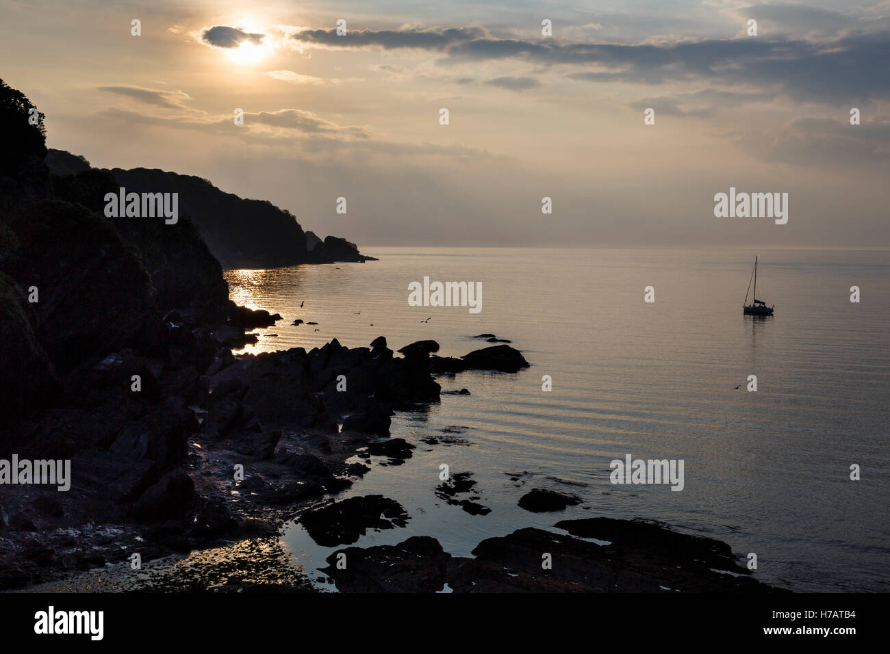 Sun setting over the bay at Combe Martin, Devon Stock Photo - Alamy