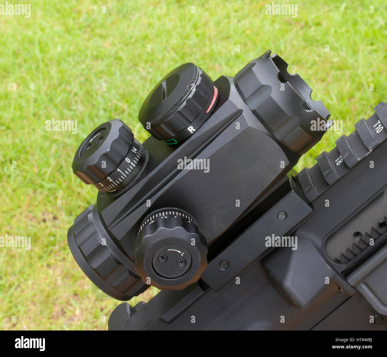 Very short scope mounted on a rifle with a green background Stock Photo ...