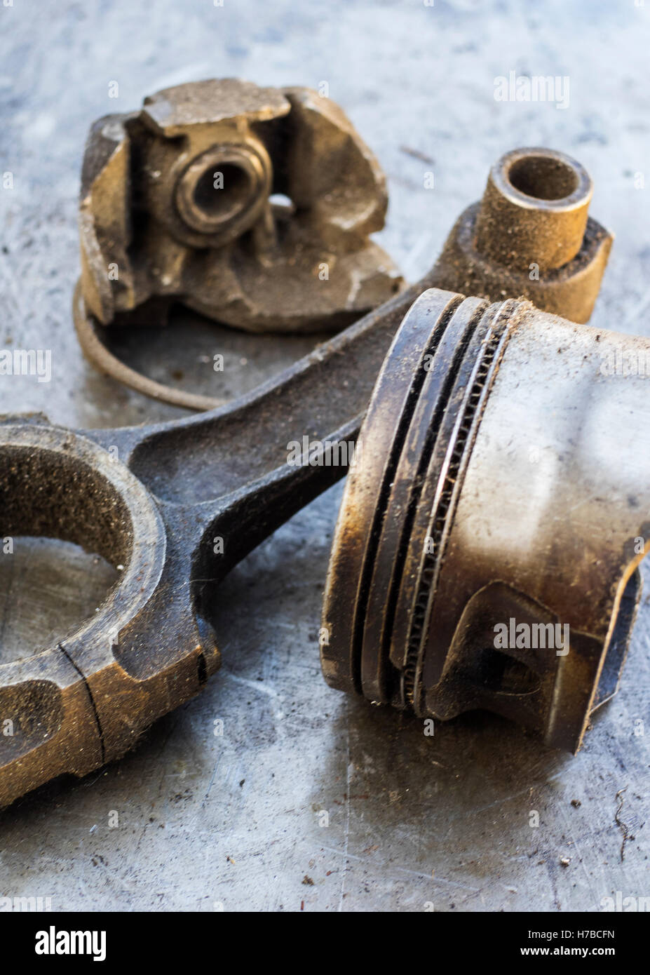 Broken and used piston on old metal background. Selective focus Stock ...