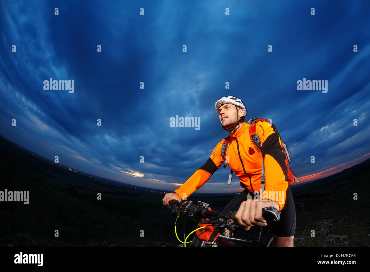 low angle view portrait of cyclist standing with mountain bike on trail ...