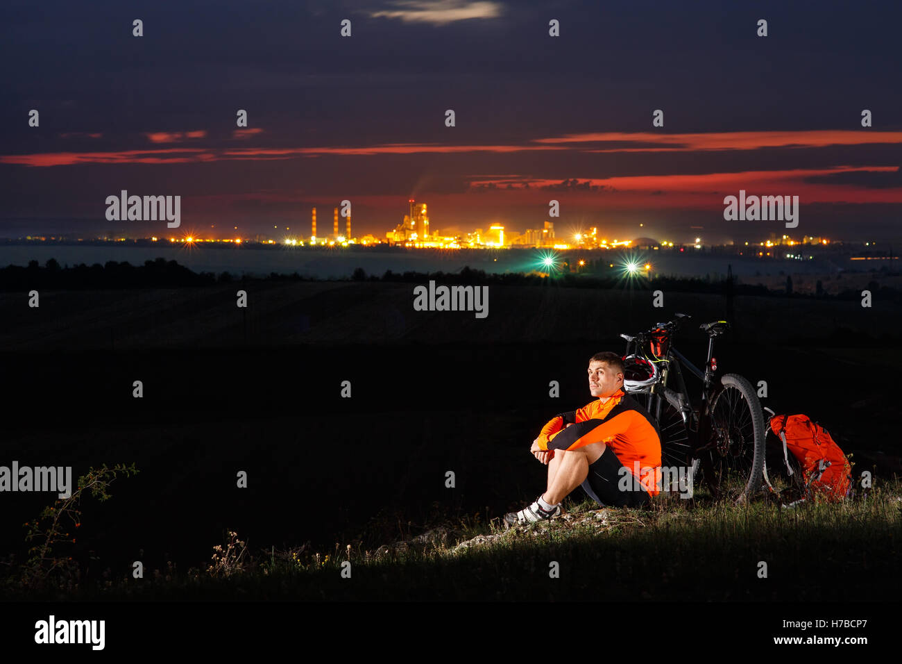 Biker resting on top of mountain with his bicycle near him. Cyclist ...