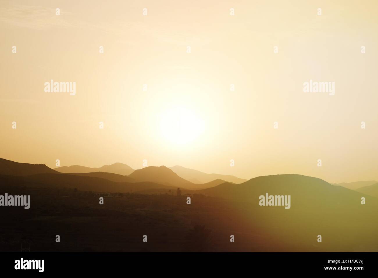 Beautiful sky in sunset with layers of the mountain Stock Photo - Alamy