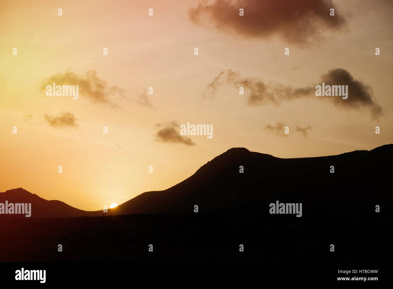 Beautiful sky in sunset with layers of the mountain Stock Photo - Alamy