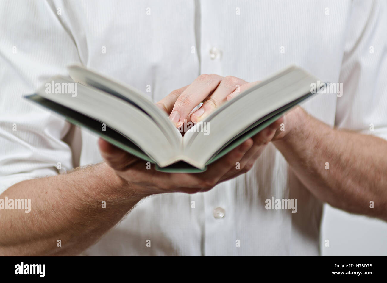 Young Adult Man's Hands Close-Up, Reading a Book Stock Photo - Alamy