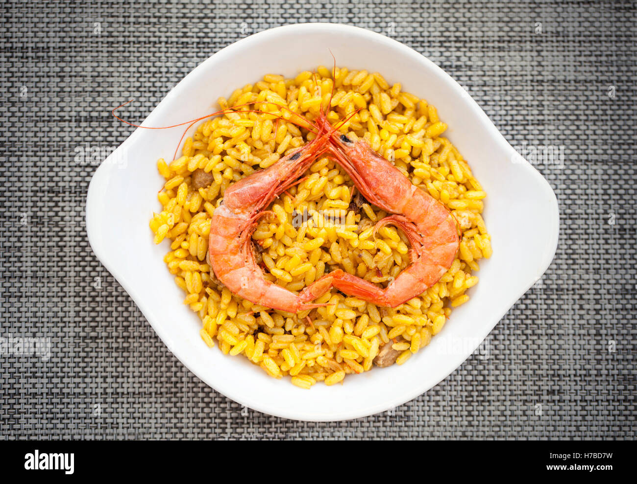 Two prawns making a heart shape on a tapa dish of Spanish paella Stock ...