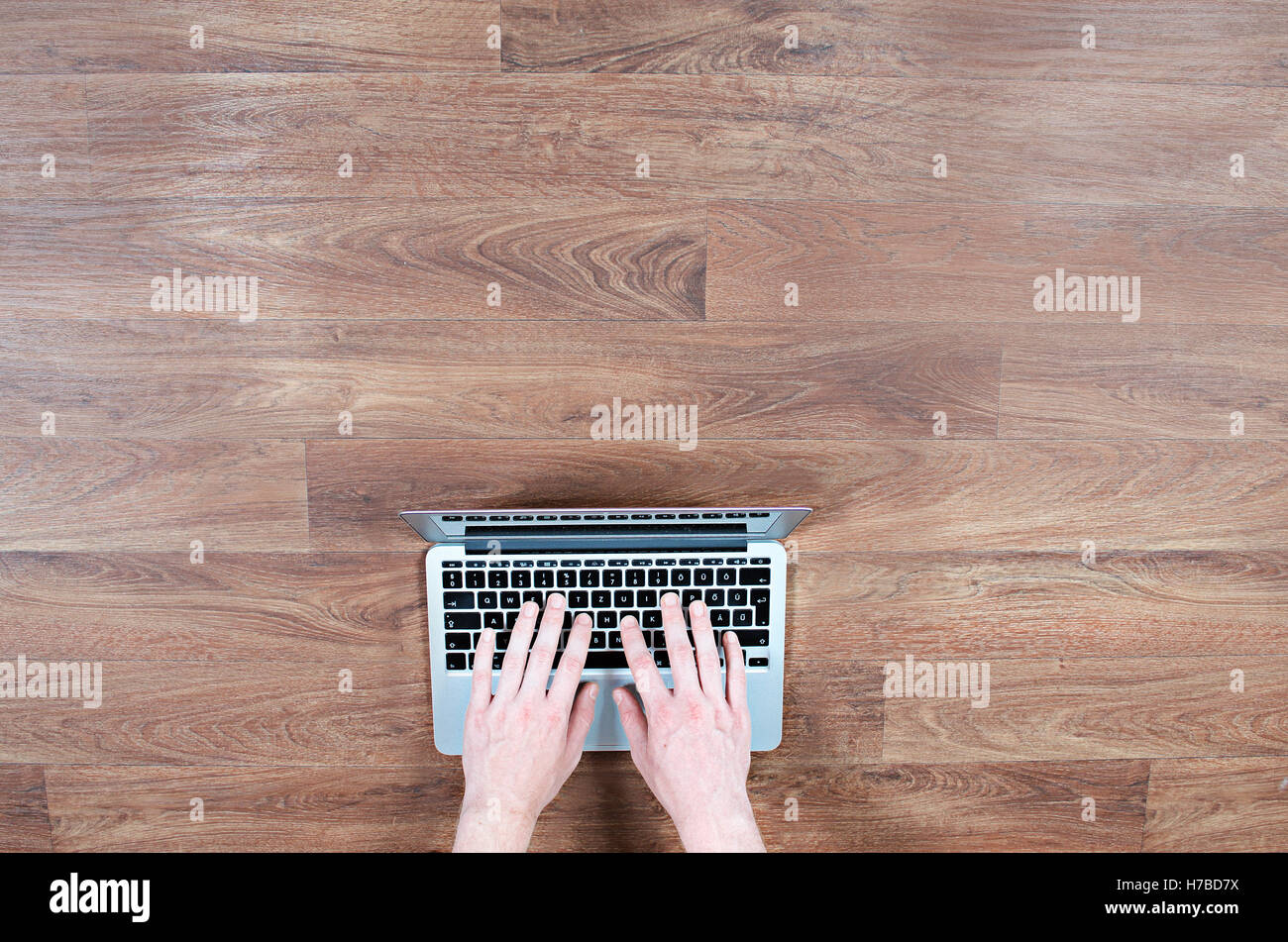 Young Adult Man Sitting on Floor with Hands on the Keyboard of a ...