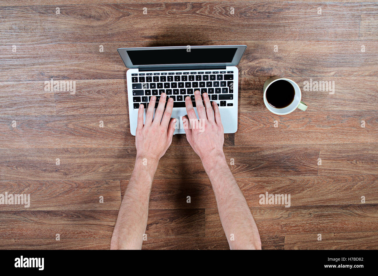 Young Adult Man Sitting on Floor with Hands on the Keyboard of a ...