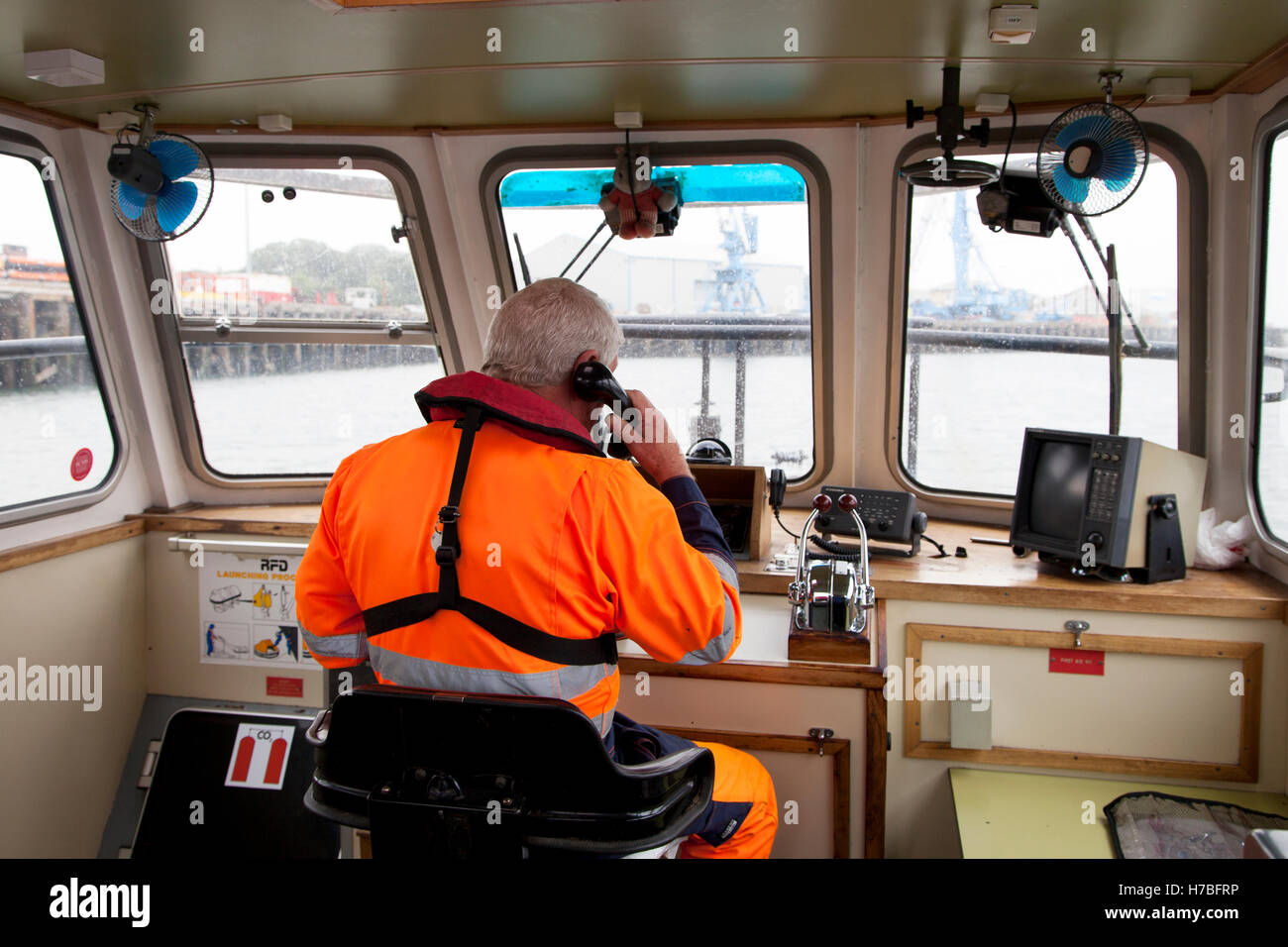 Man steering pilot boat at Blyth harbour in Northumberland, England ...