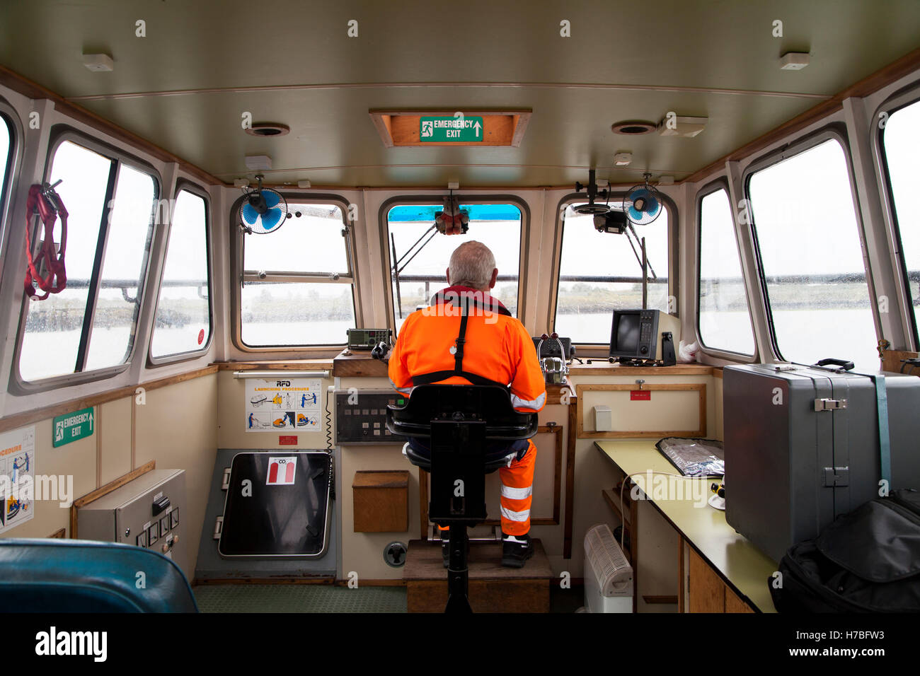 Man steering pilot boat at Blyth harbour in Northumberland, England ...
