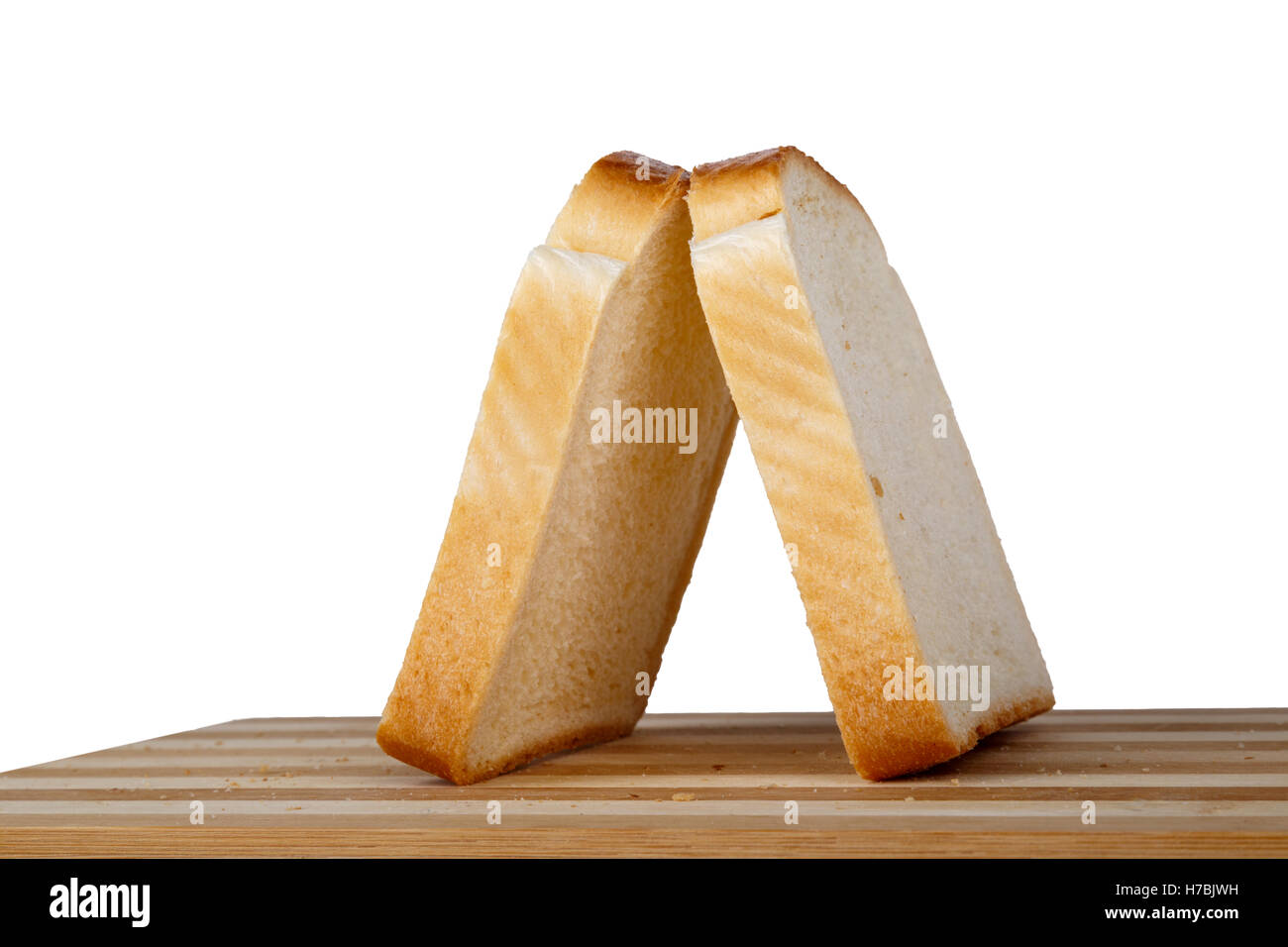 Side view of slices of toast bread on breadboard, isolated on white ...