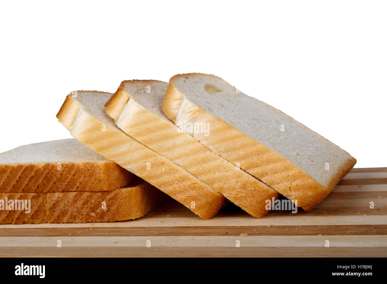 Side view of slices of toast bread on breadboard, isolated on white ...