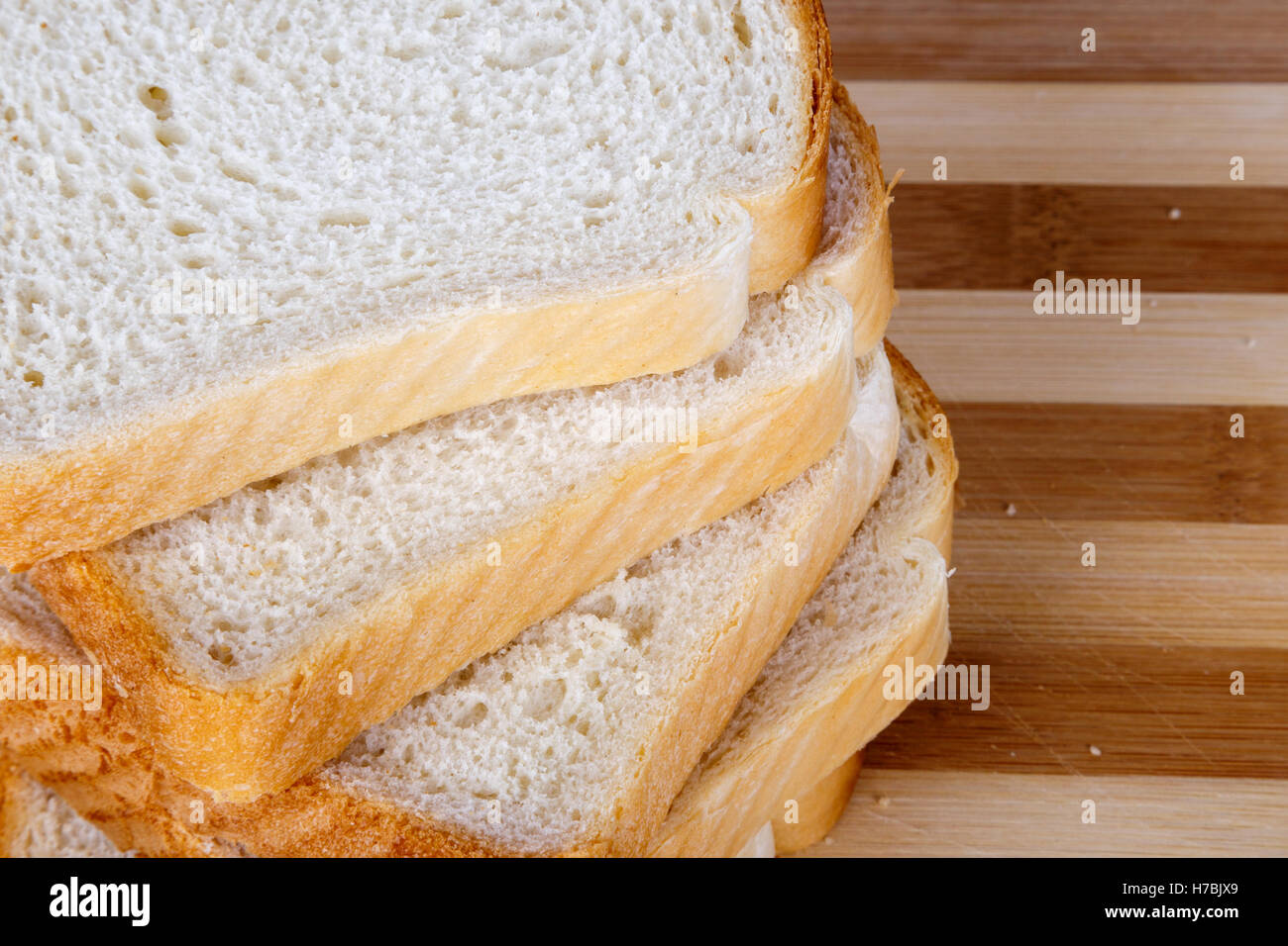 Slices of toast bread on breadboard, isolated on white background Stock ...