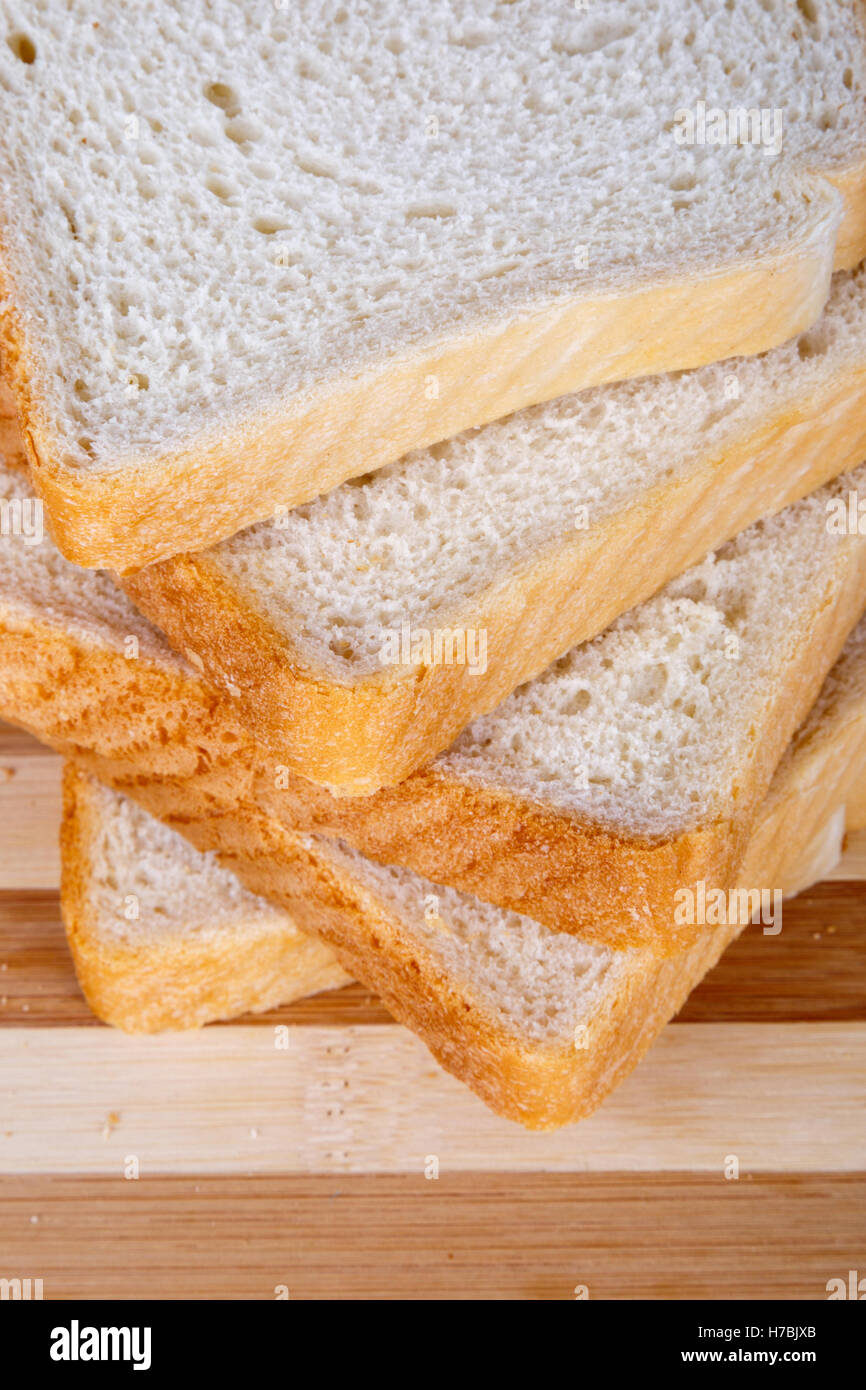 Slices of toast bread on breadboard, isolated on white background Stock ...