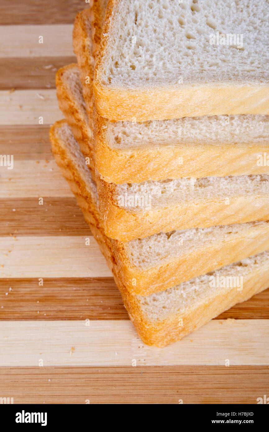 Slices of toast bread on breadboard, isolated on white background Stock ...