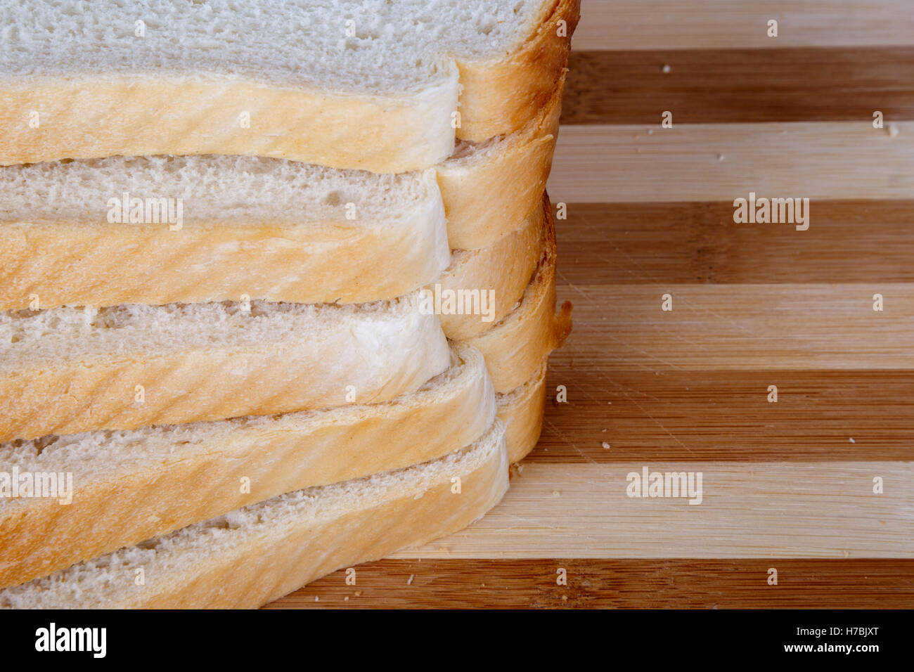 Slices of toast bread on breadboard, isolated on white background Stock ...