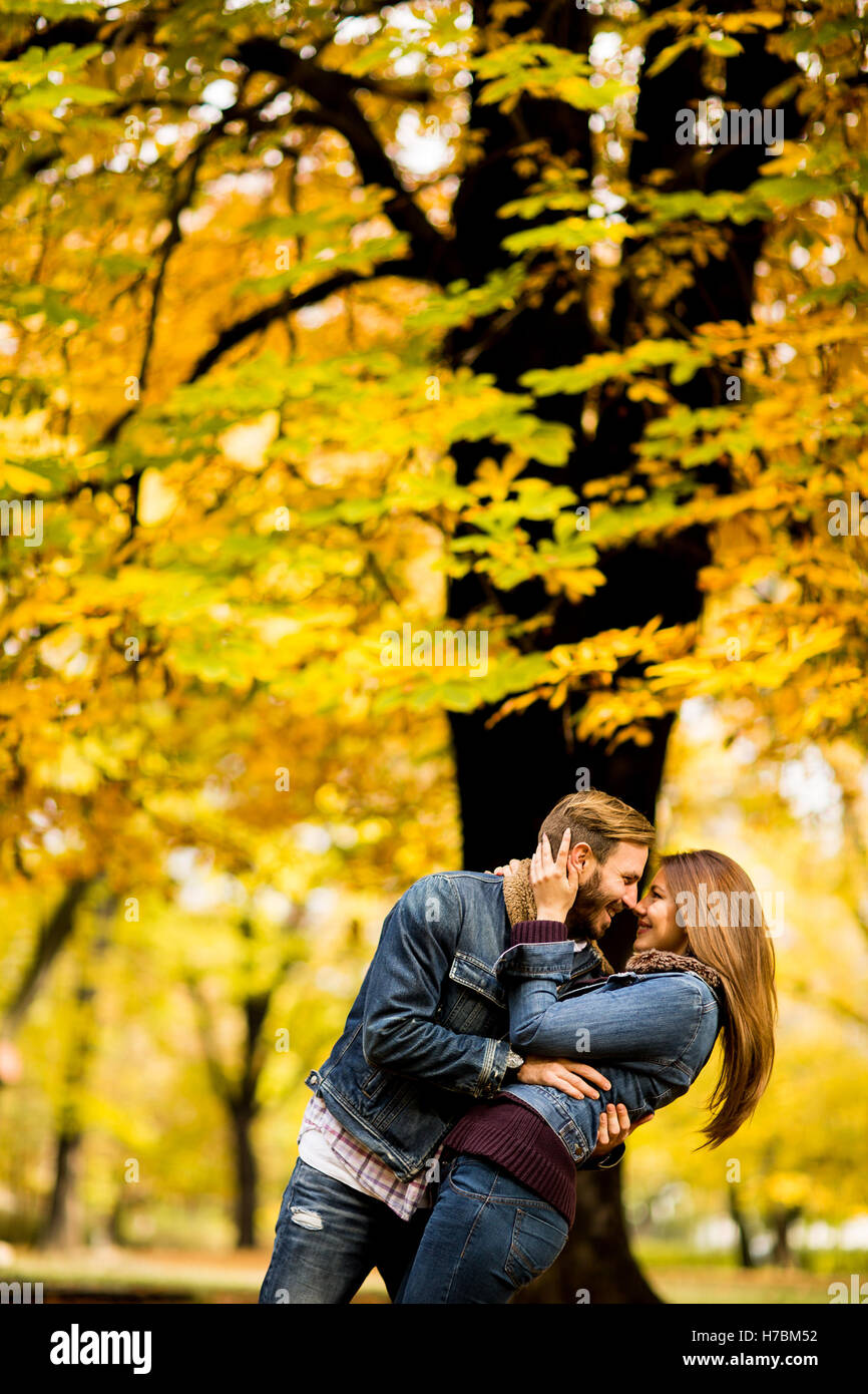 Young couple having fun in the autumn park Stock Photo - Alamy