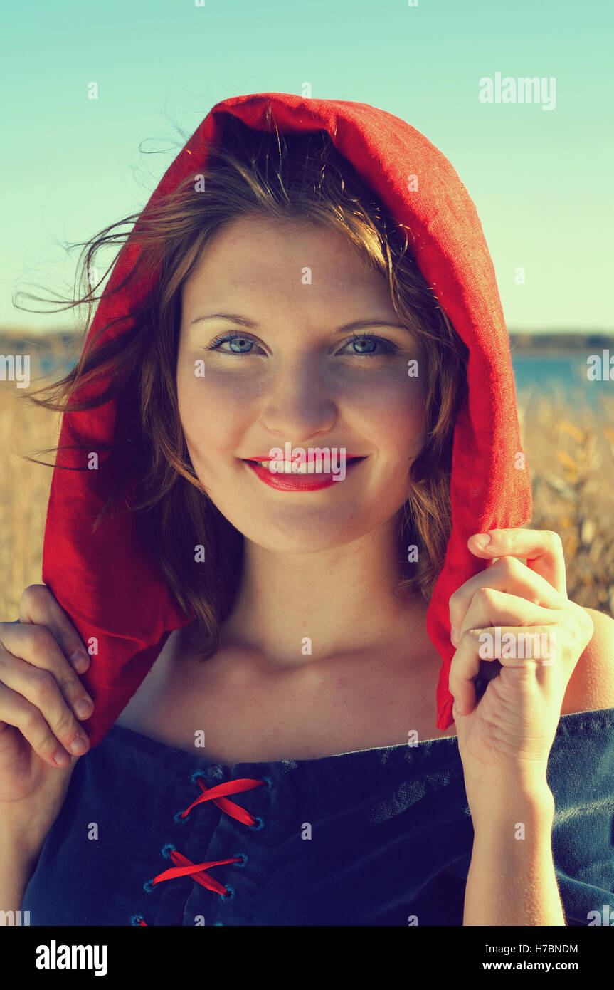 red Riding hood standing in a wood . beautiful girl in medieval dress ...