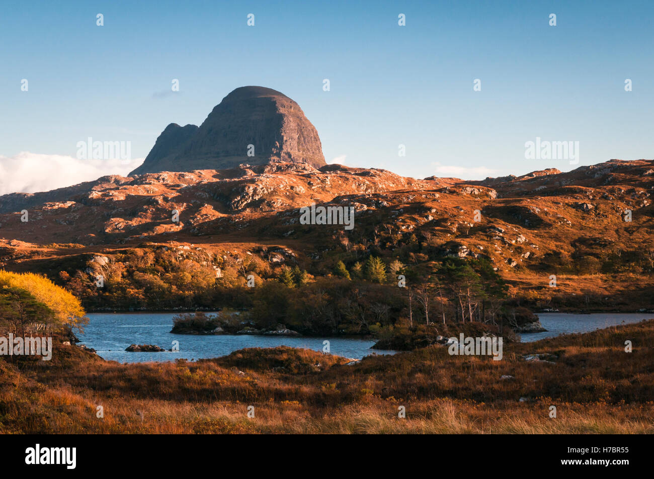 A landscape image looking across Loch Druim Suardalain to Suilven, a ...