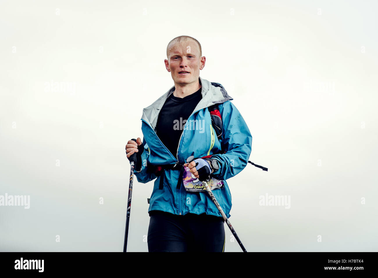closeup of runner skyrunner with walking sticks running on background ...