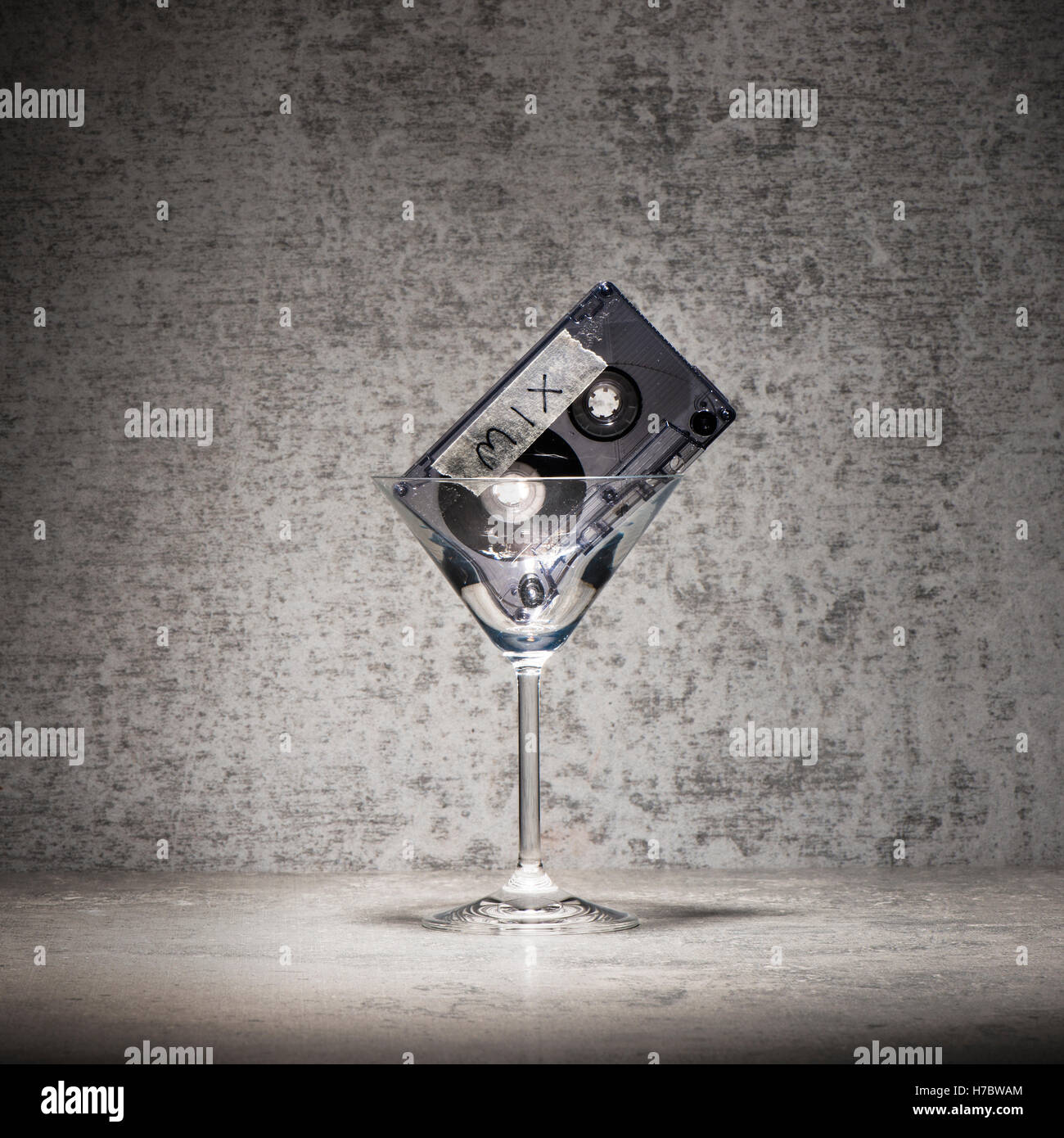 Music mix for a party. Mixed tape in a cocktail glass. Still life with ...