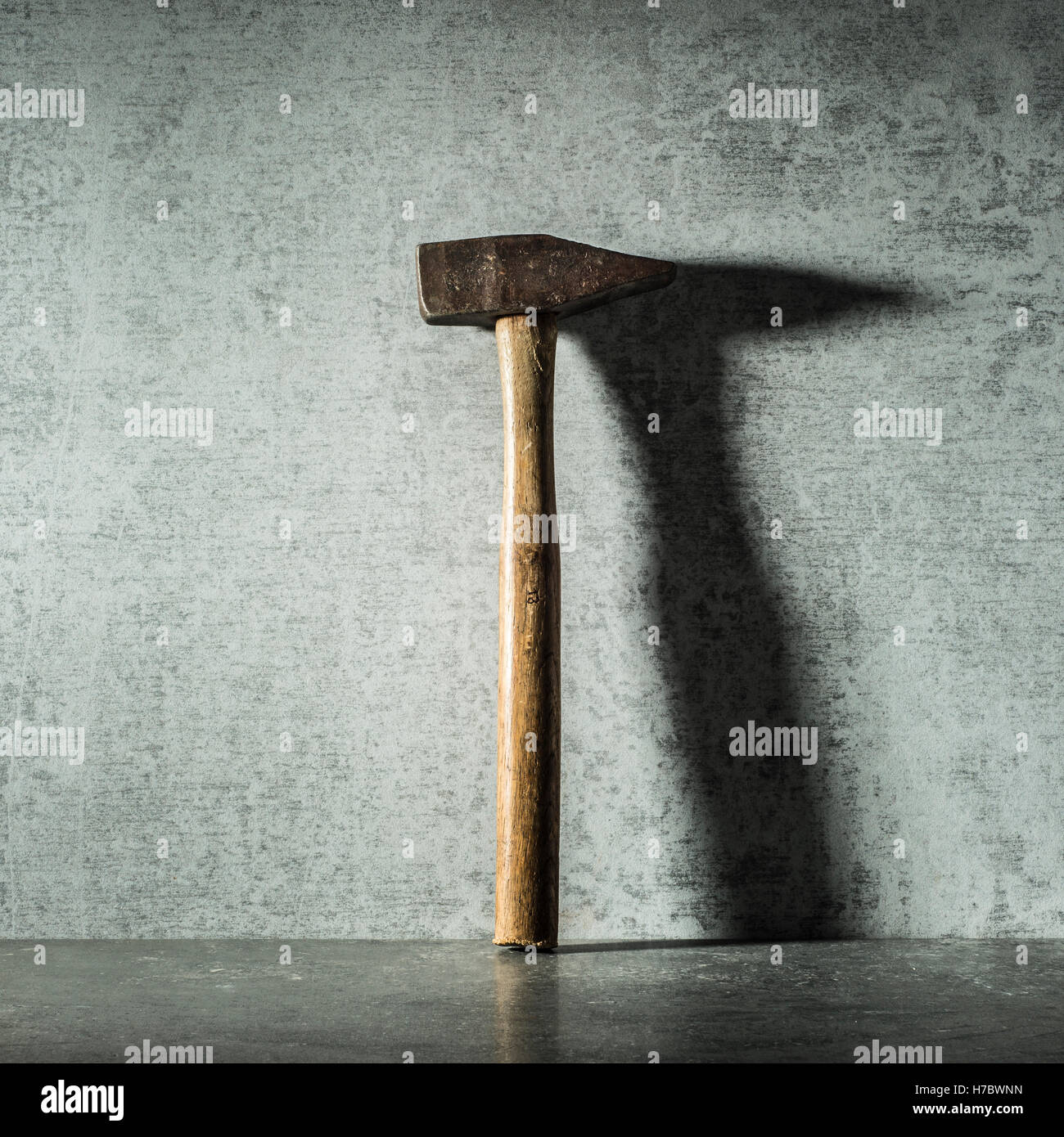 Vintage hammer and shadow on stone wall. Still life of work tool ...