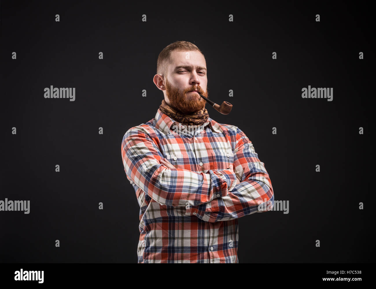 Elegant bearded man holding smoking pipe Stock Photo - Alamy