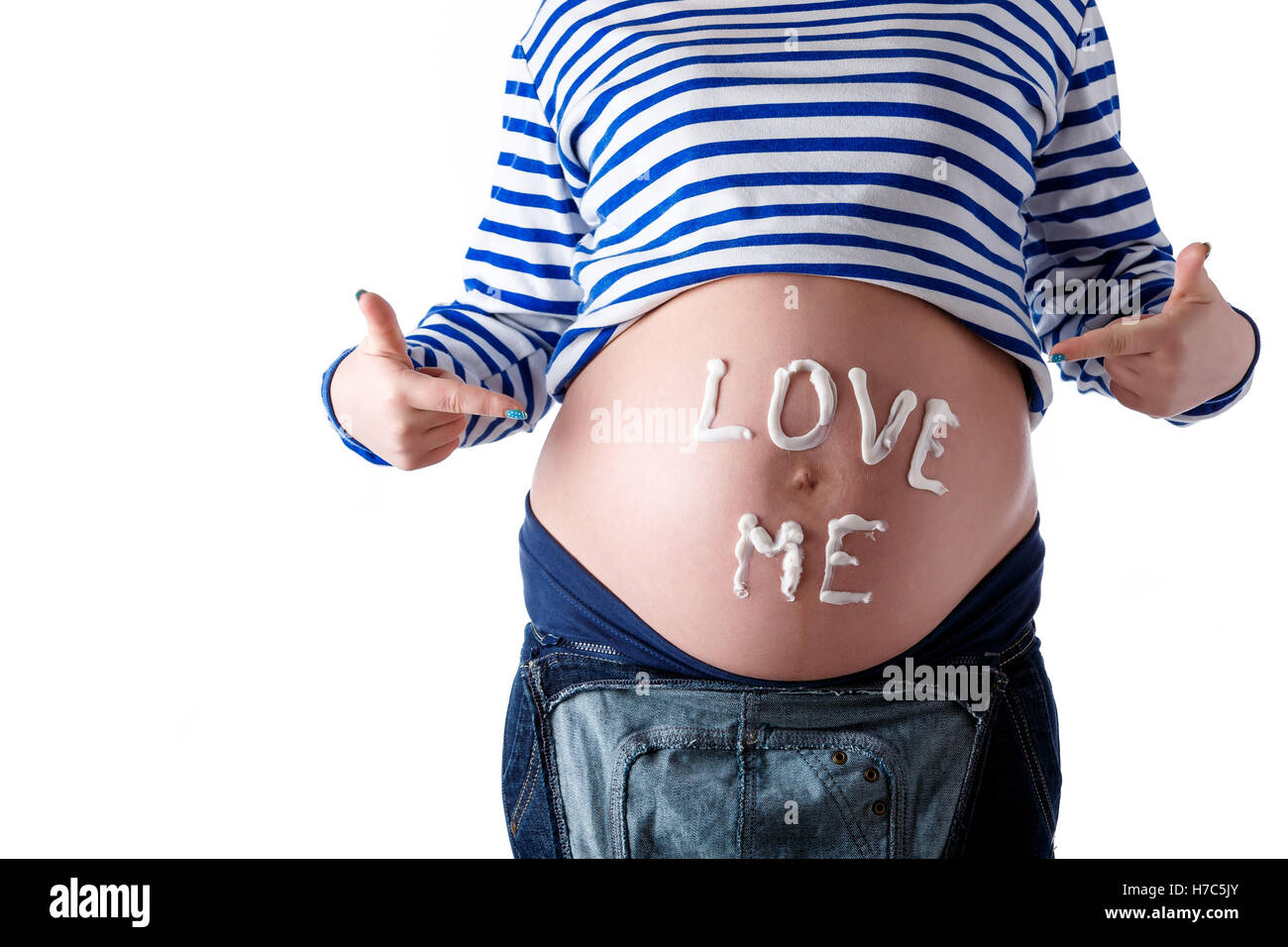 Pregnant woman writing 'love me' word on her belly. Isolate Stock Photo ...