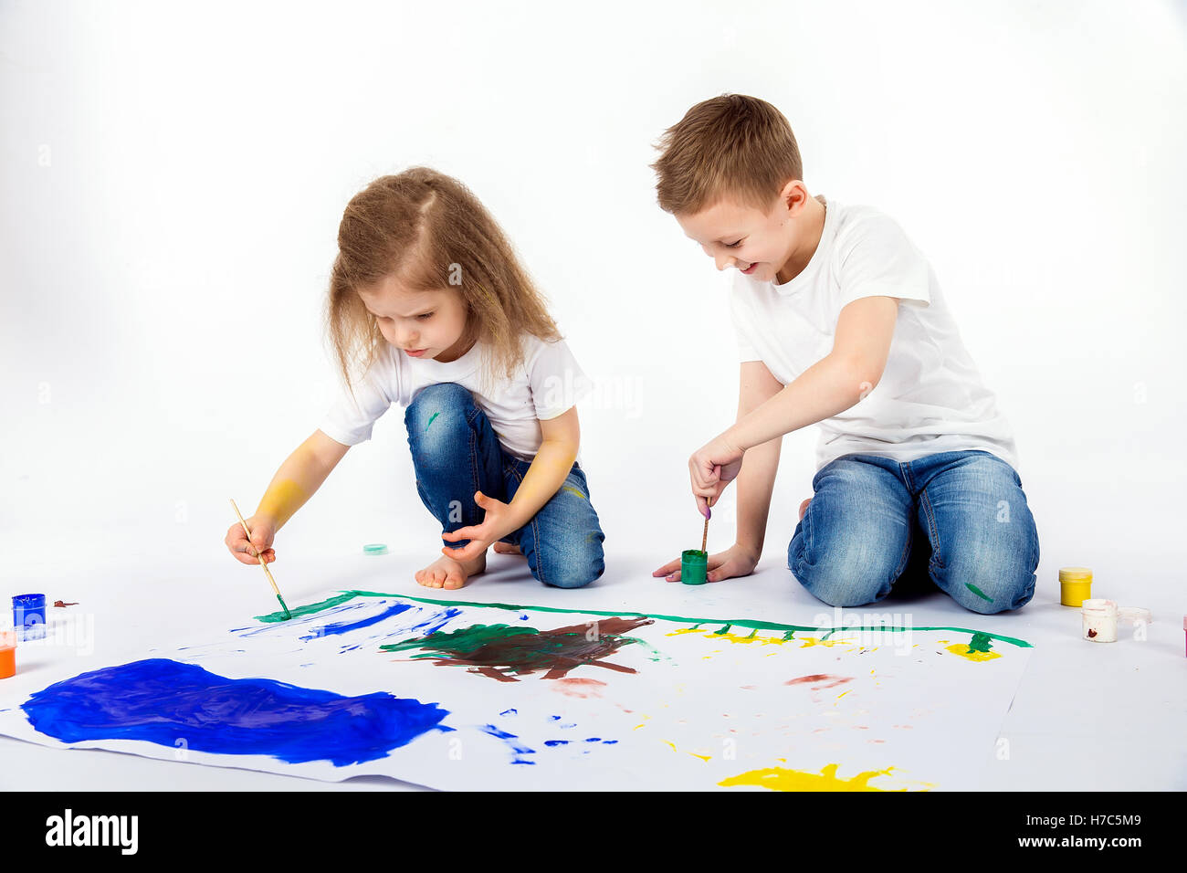Sister and brother painting using bright colors, brushes Stock Photo ...