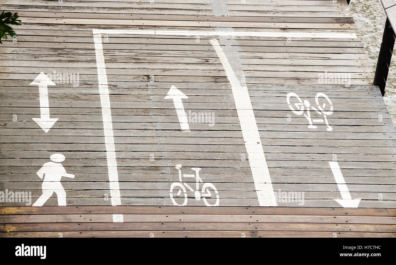 Urban boardwalk with spray-painted wayfinding directional signage for ...