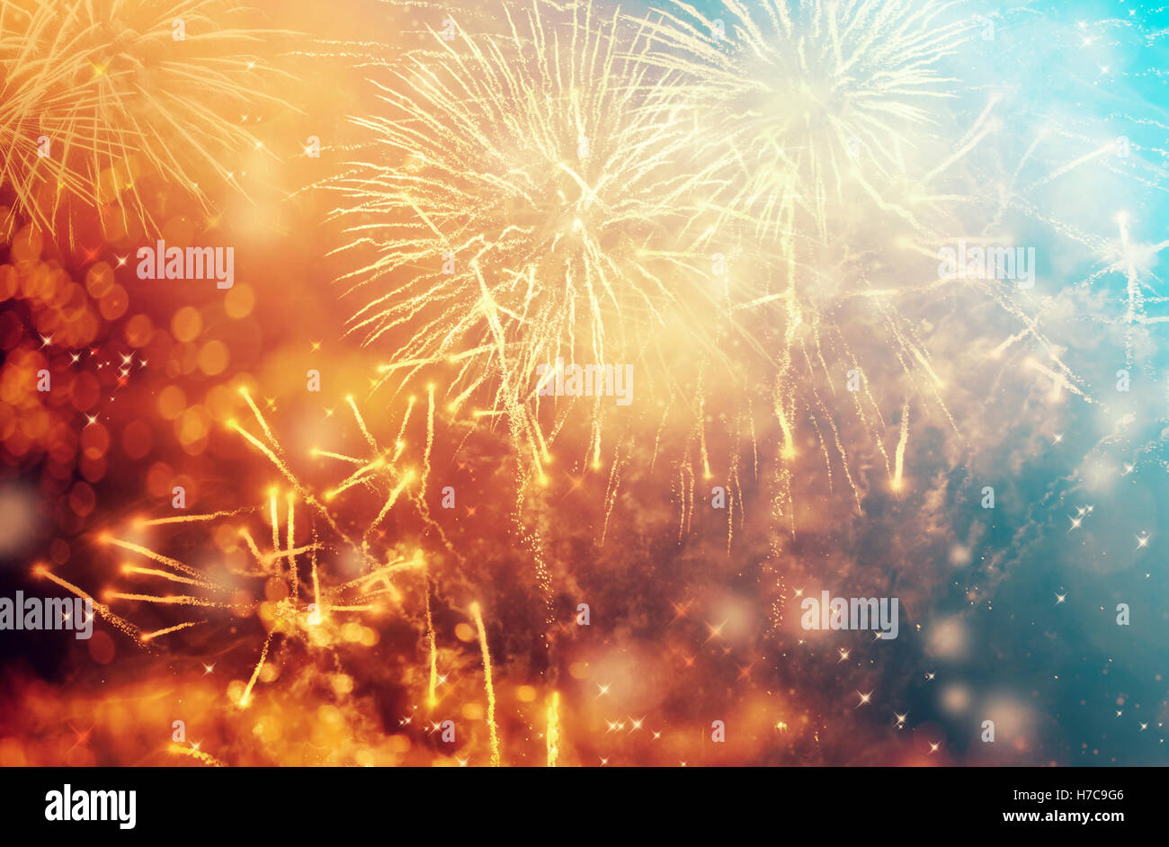 Abstract colorful holiday background of sky with fireworks and stars ...