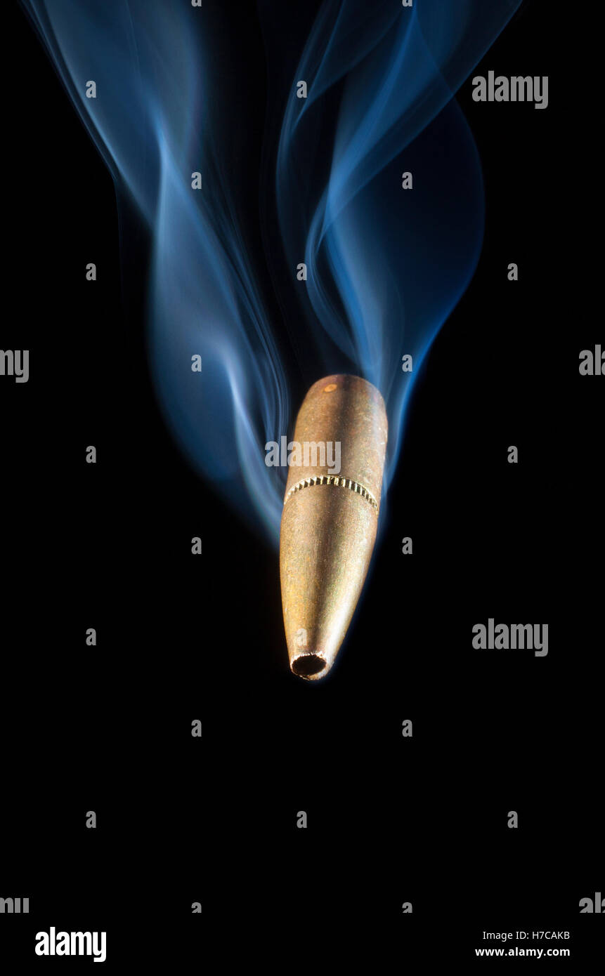 Bullet with copper coating and smoke coming close to the viewer Stock ...