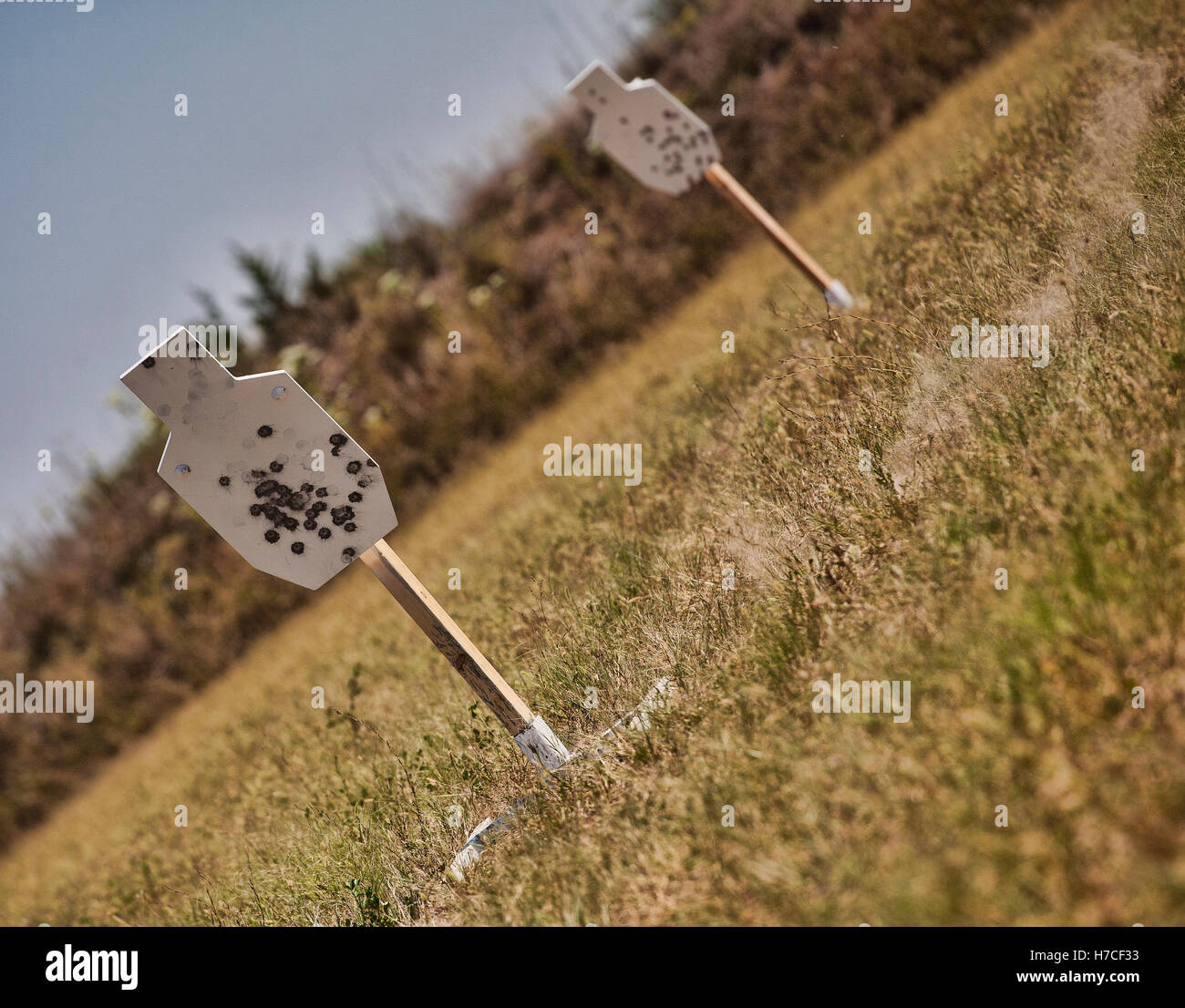 Bullet fragments hitting the back steel target and raising dust on the ...