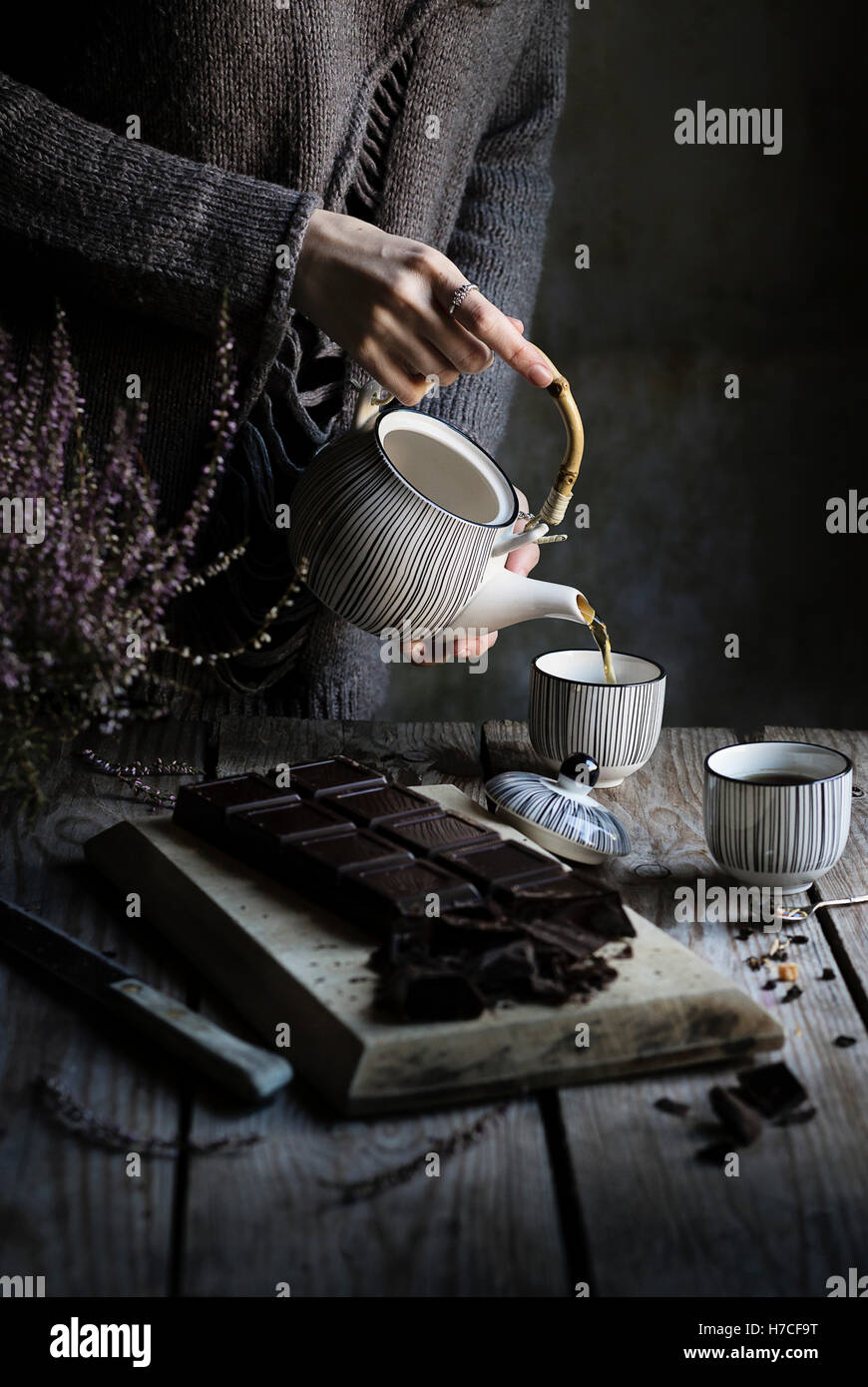 Tea time: woman pouring tea in a cup Stock Photo - Alamy
