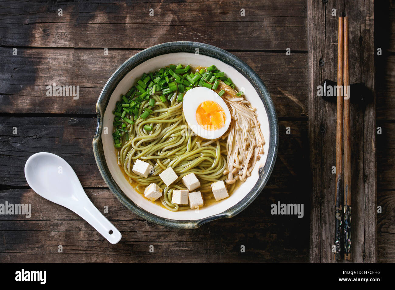Bowl of asian style soup with green tea soba noodles, egg, mushrooms ...