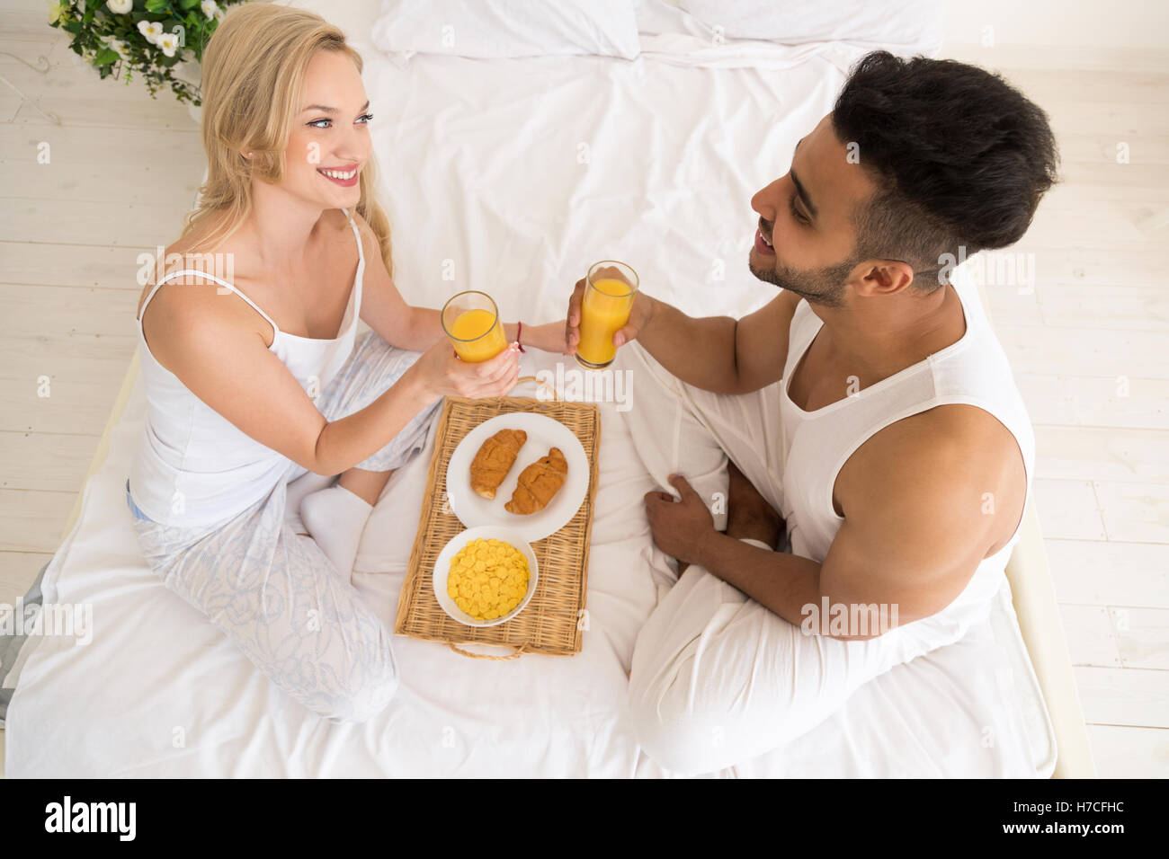 Young Couple Breakfast Sitting In Bed, Happy Smile Hispanic Man And ...