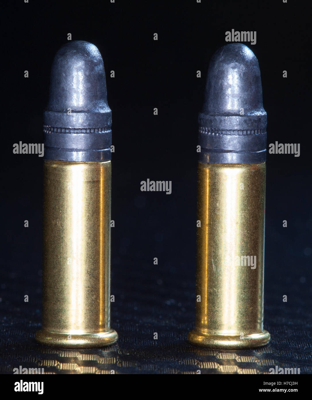 Two rim fire cartridges on a dark background Stock Photo - Alamy