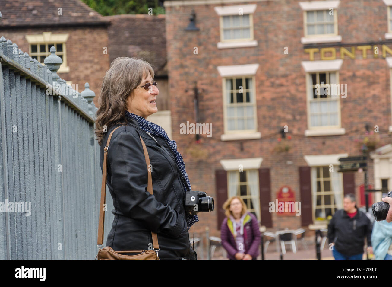 A woman with a camera around her neck admired the view from the iron ...