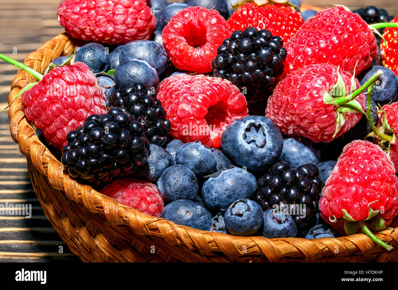 Raspberry, blackberry and blueberry on the old wooden board,background ...