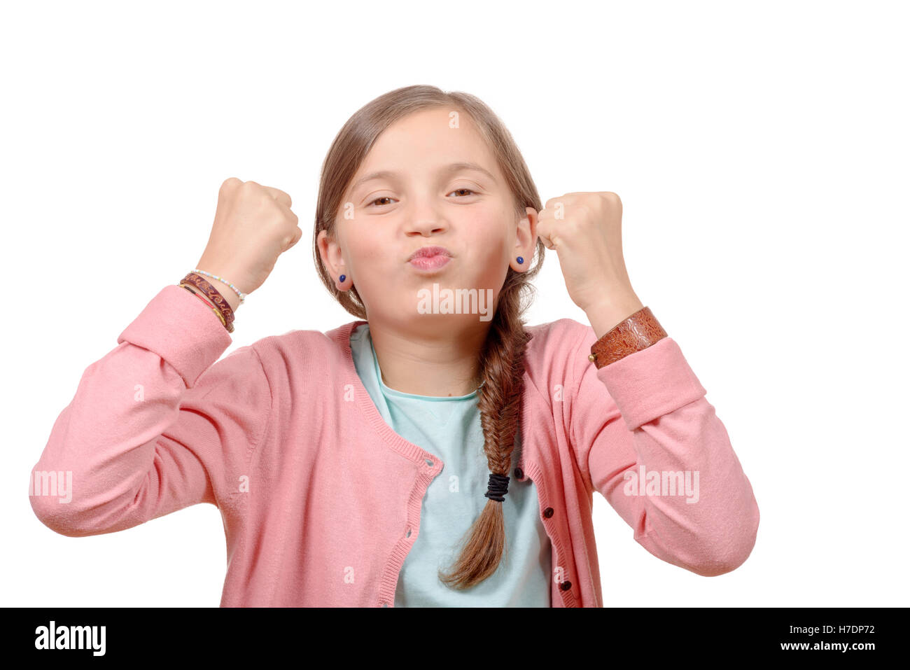 Cute little years girl raises her hands in a victory sign on white ...