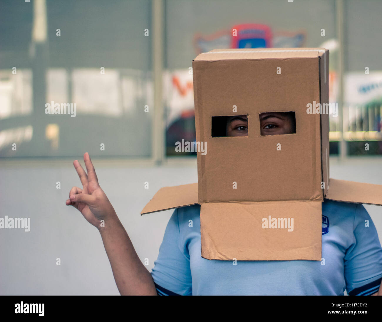 Photograph of a teen with a carton head mask Stock Photo - Alamy