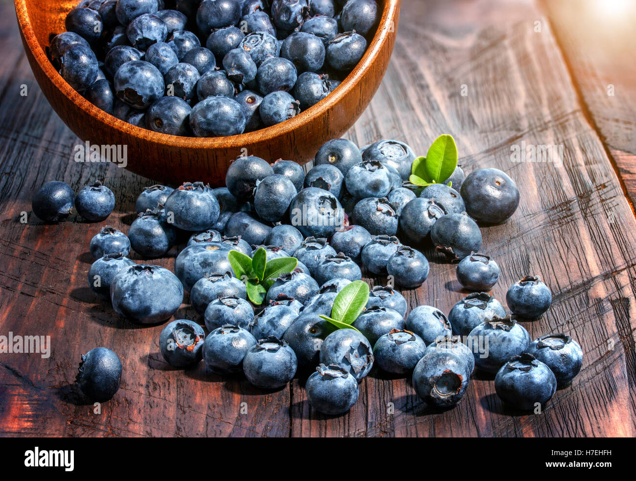 Blueberries on a old wooden table outdoors Stock Photo - Alamy