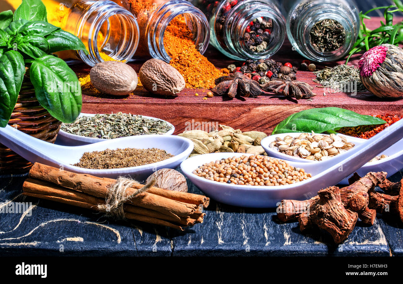 Colorful aromatic spices and herbs on an old oak wooden brown ...