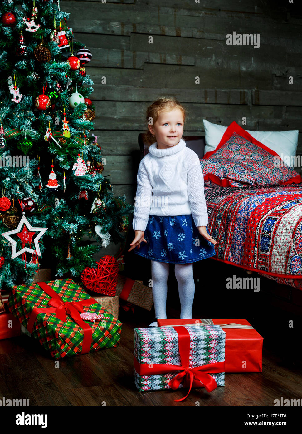 happy child at home with Christmas tree and presents Stock Photo - Alamy