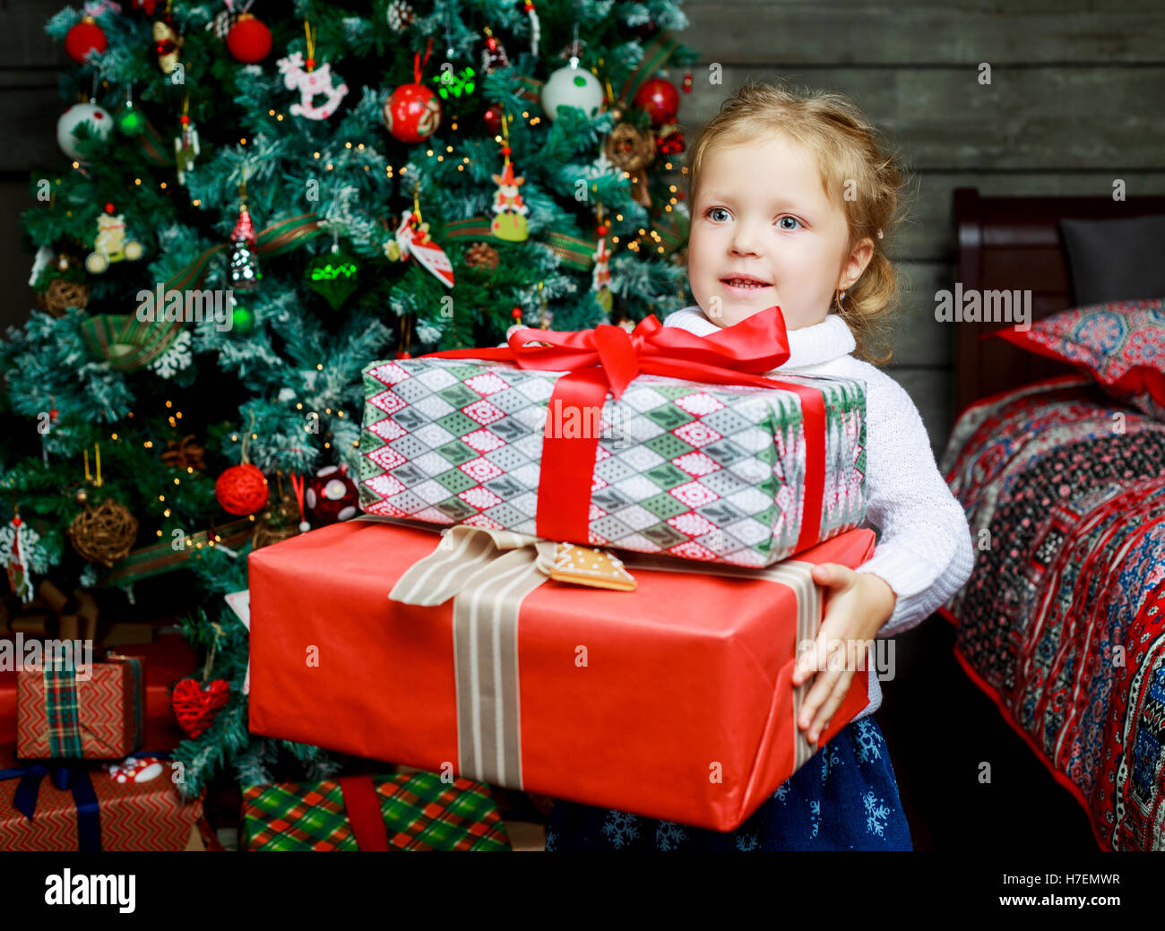 happy child at home with Christmas tree and presents Stock Photo - Alamy