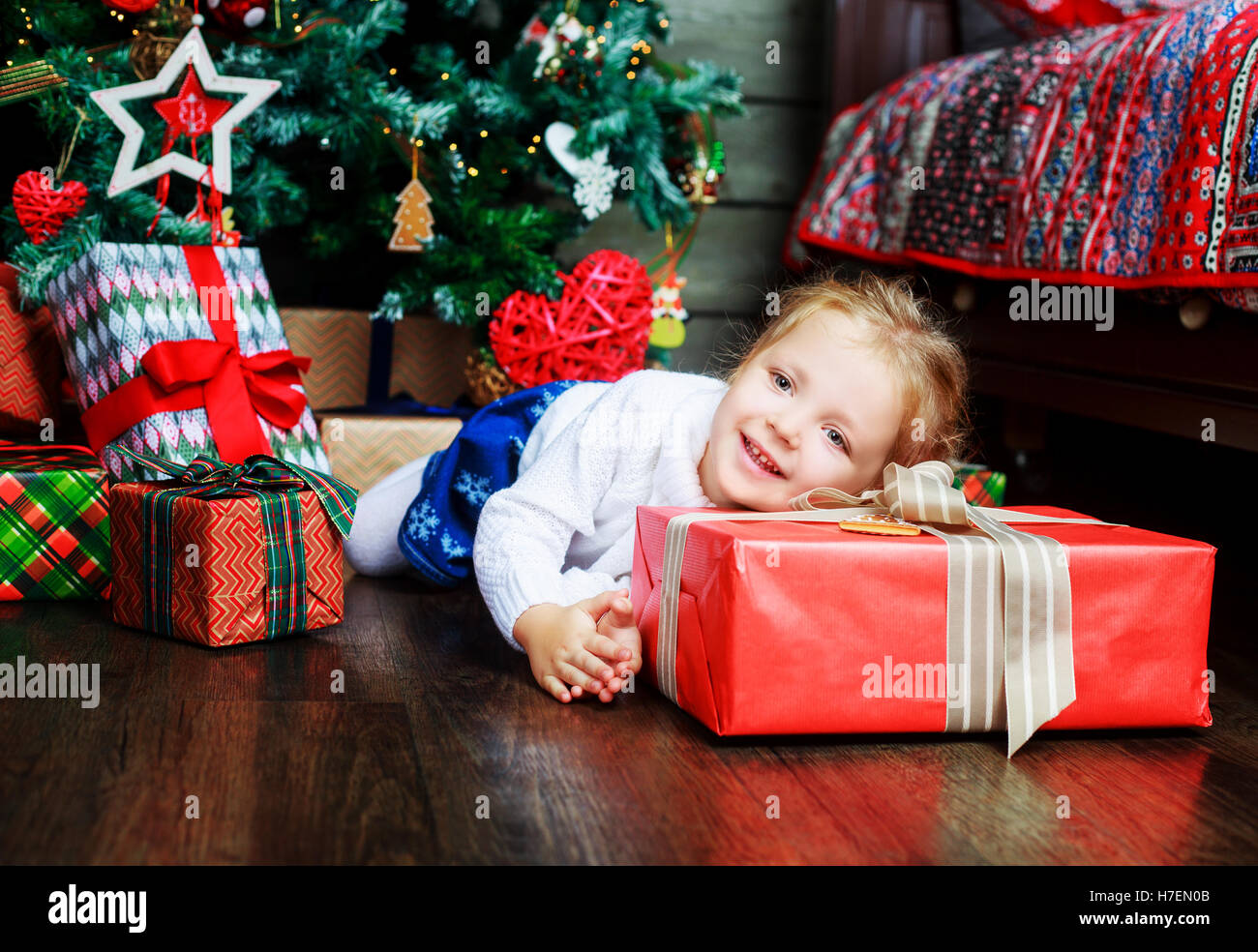 happy child at home with Christmas tree and presents Stock Photo - Alamy