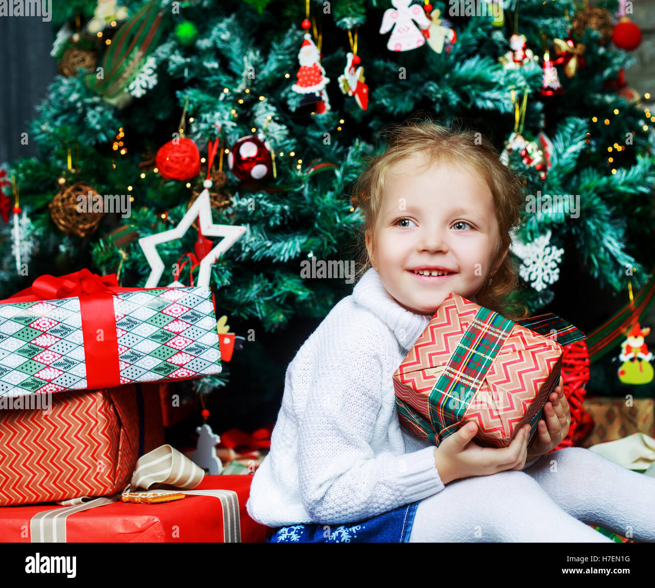 happy child at home with Christmas tree and presents Stock Photo - Alamy