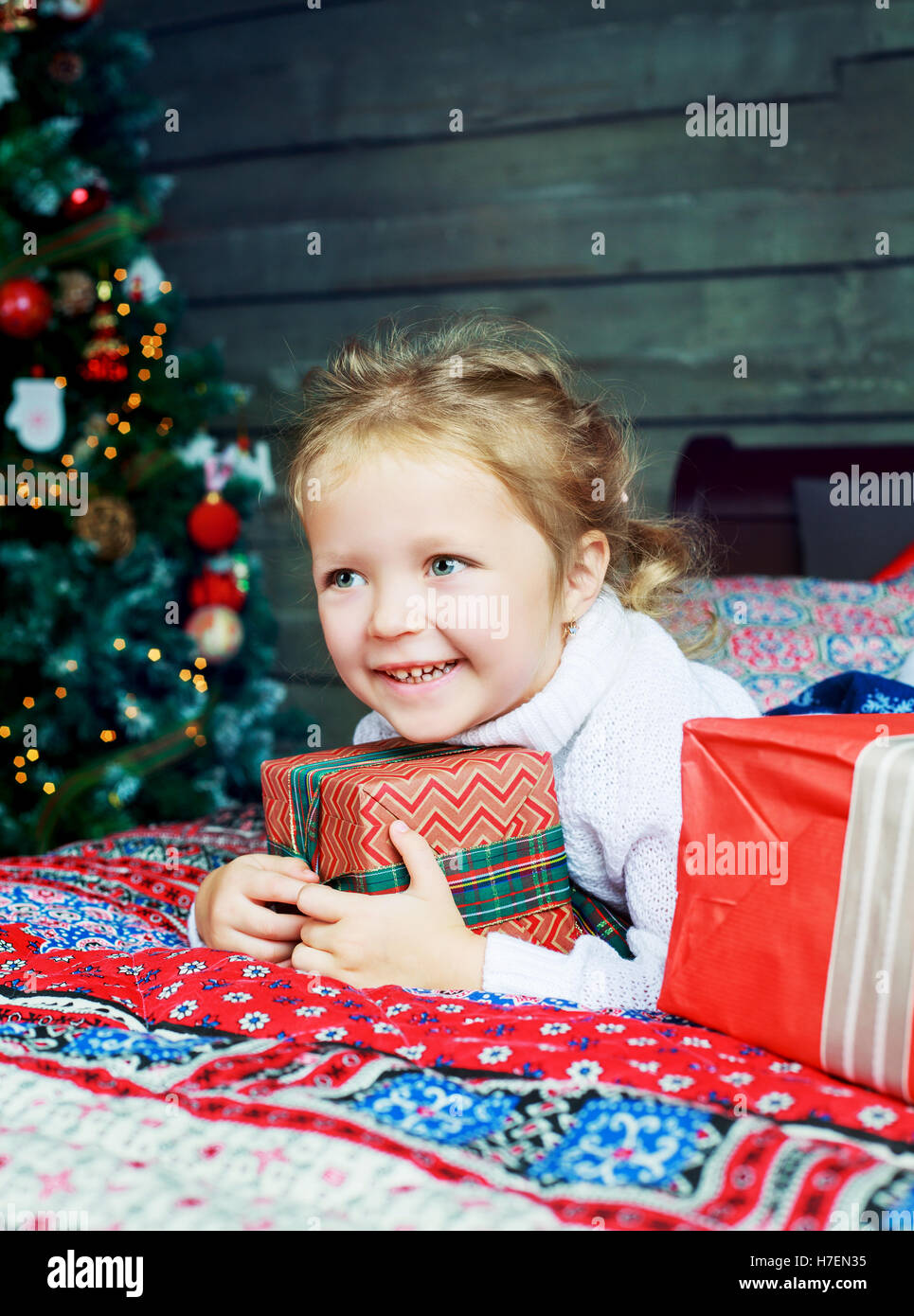 happy child at home with Christmas tree and presents Stock Photo - Alamy