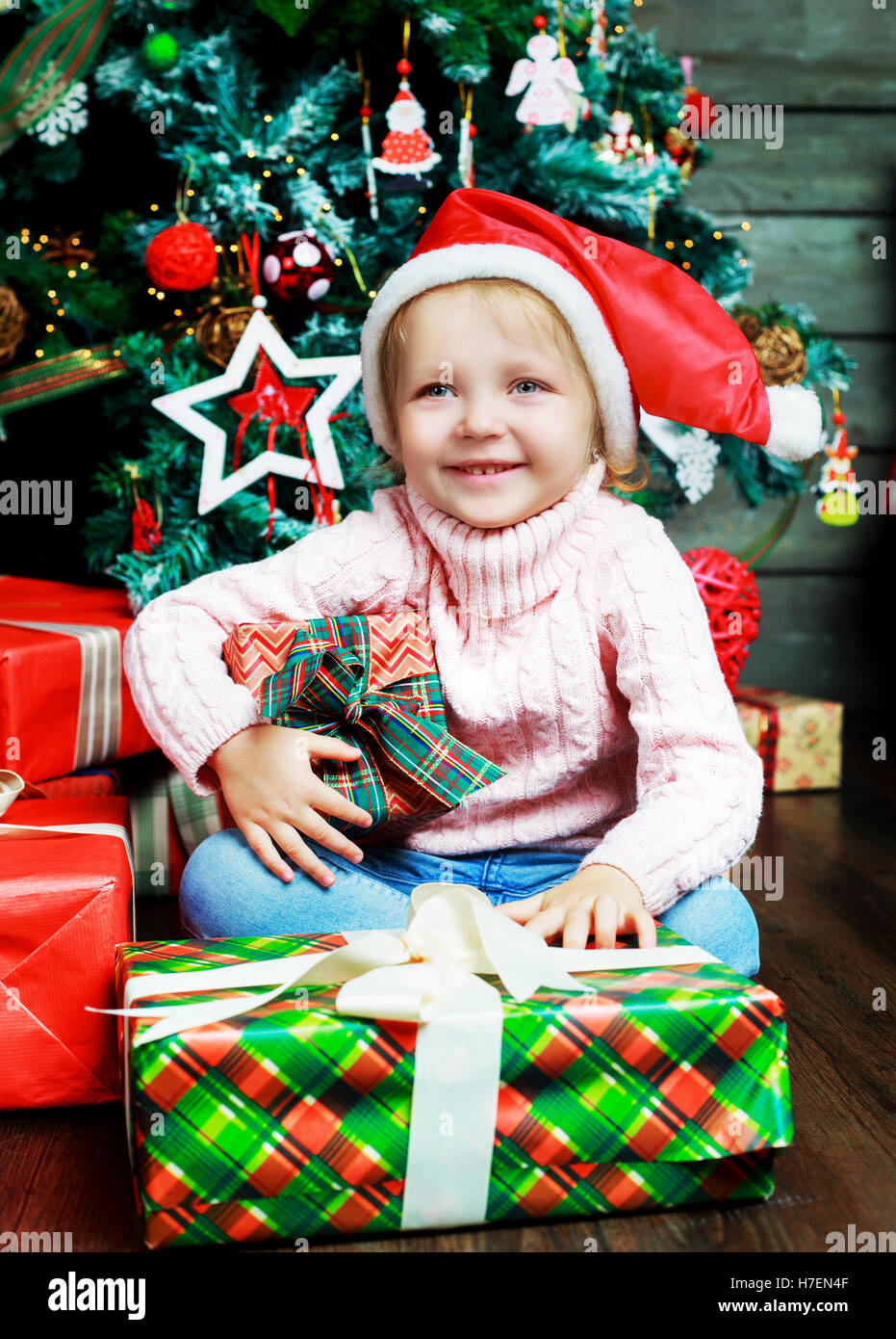 happy child at home with Christmas tree and presents Stock Photo - Alamy