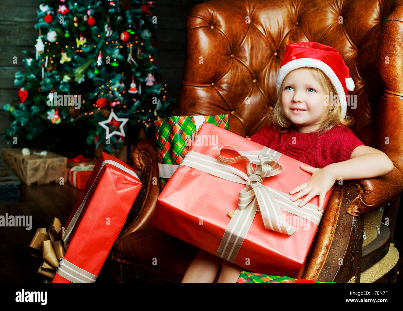 happy child at home with Christmas tree and presents Stock Photo - Alamy