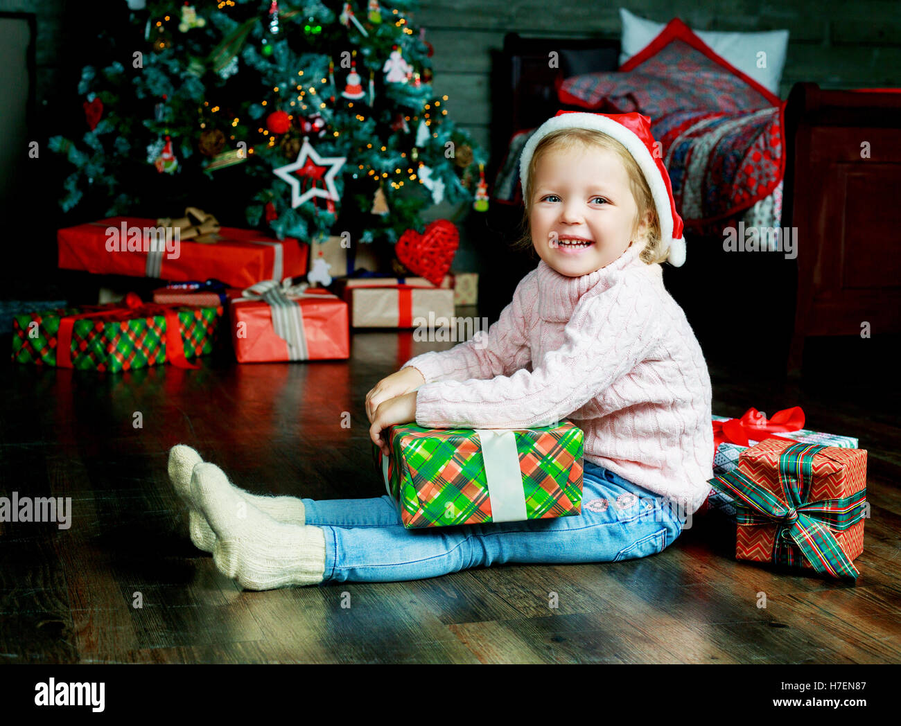 happy child at home with Christmas tree and presents Stock Photo - Alamy
